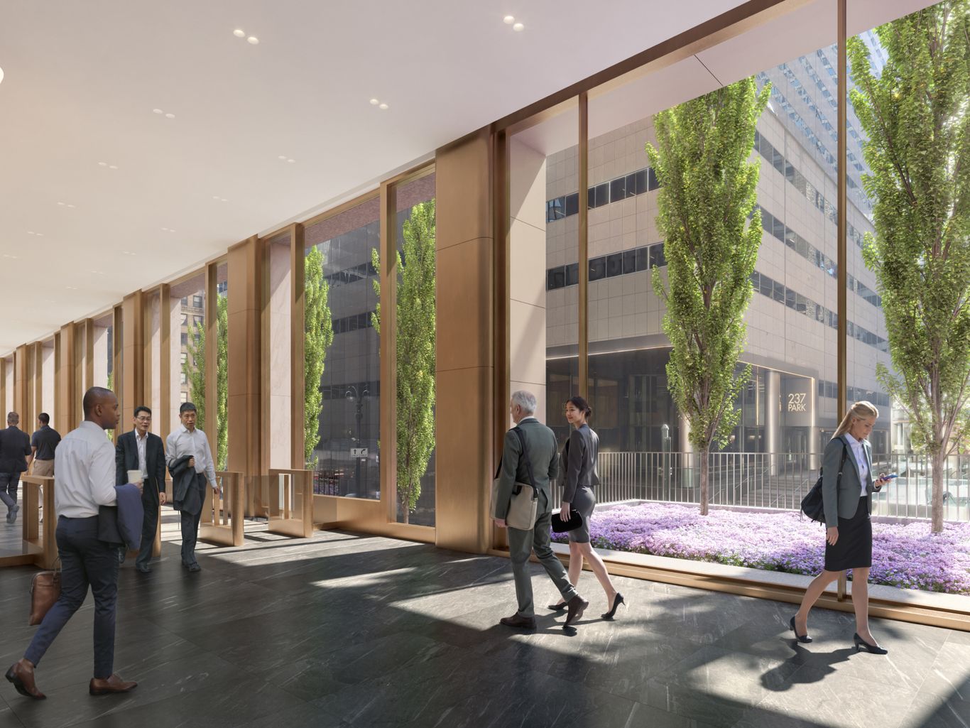 A double-height, light-flooded lobby looking out onto lush, new landscaping